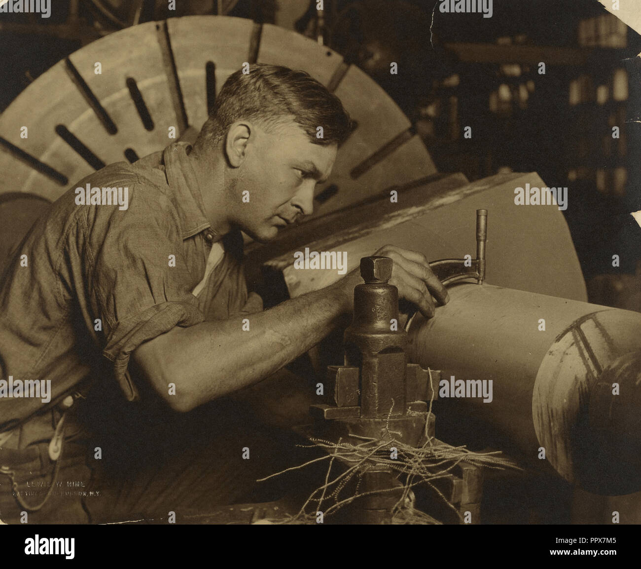 Man with Micrometer Measuring a Shaft to a Thousandth of an Inch; Lewis ...