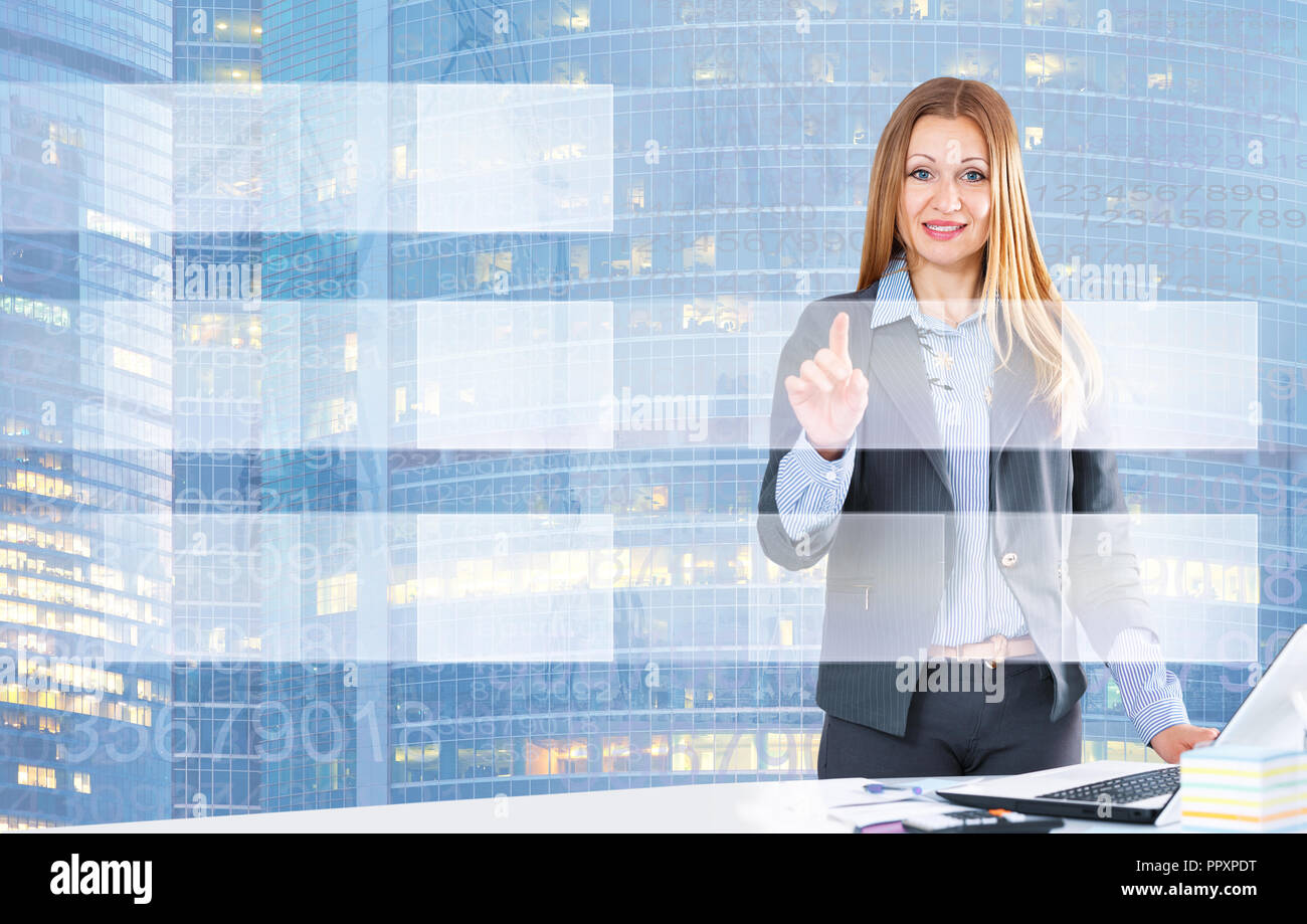 Woman touching screen on the background of modern glass buildings Stock ...
