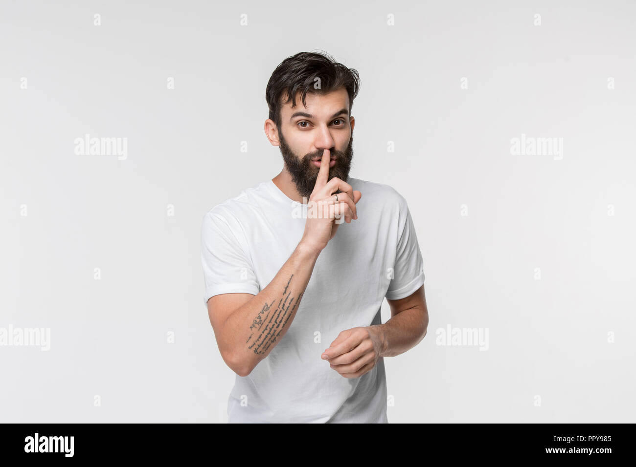 Secret, gossip concept. Young man whispering a secret behind his hand ...