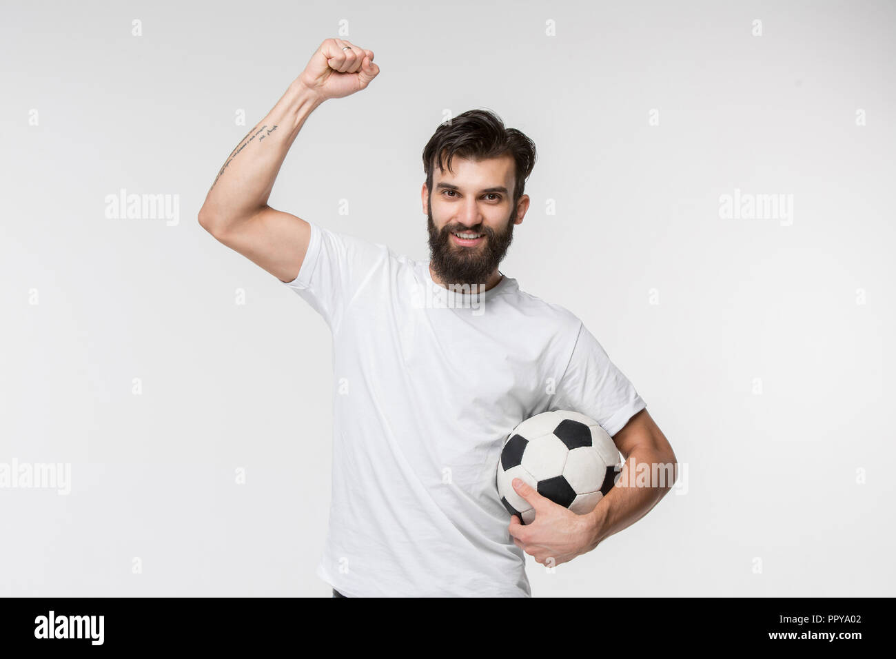Young soccer player with ball in front of white studio background Stock ...