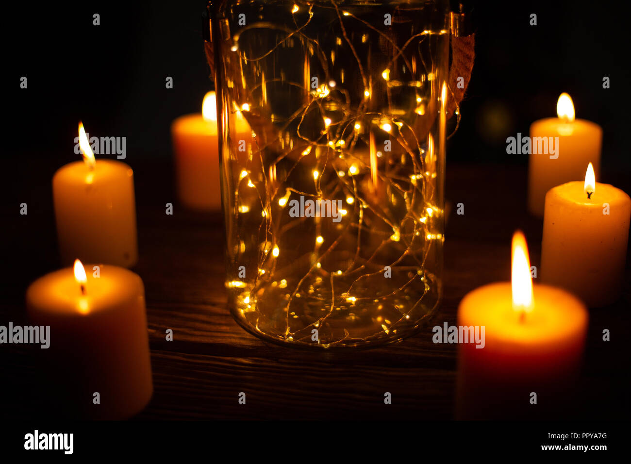 christmas candles with an electric garland in a jar Stock Photo - Alamy