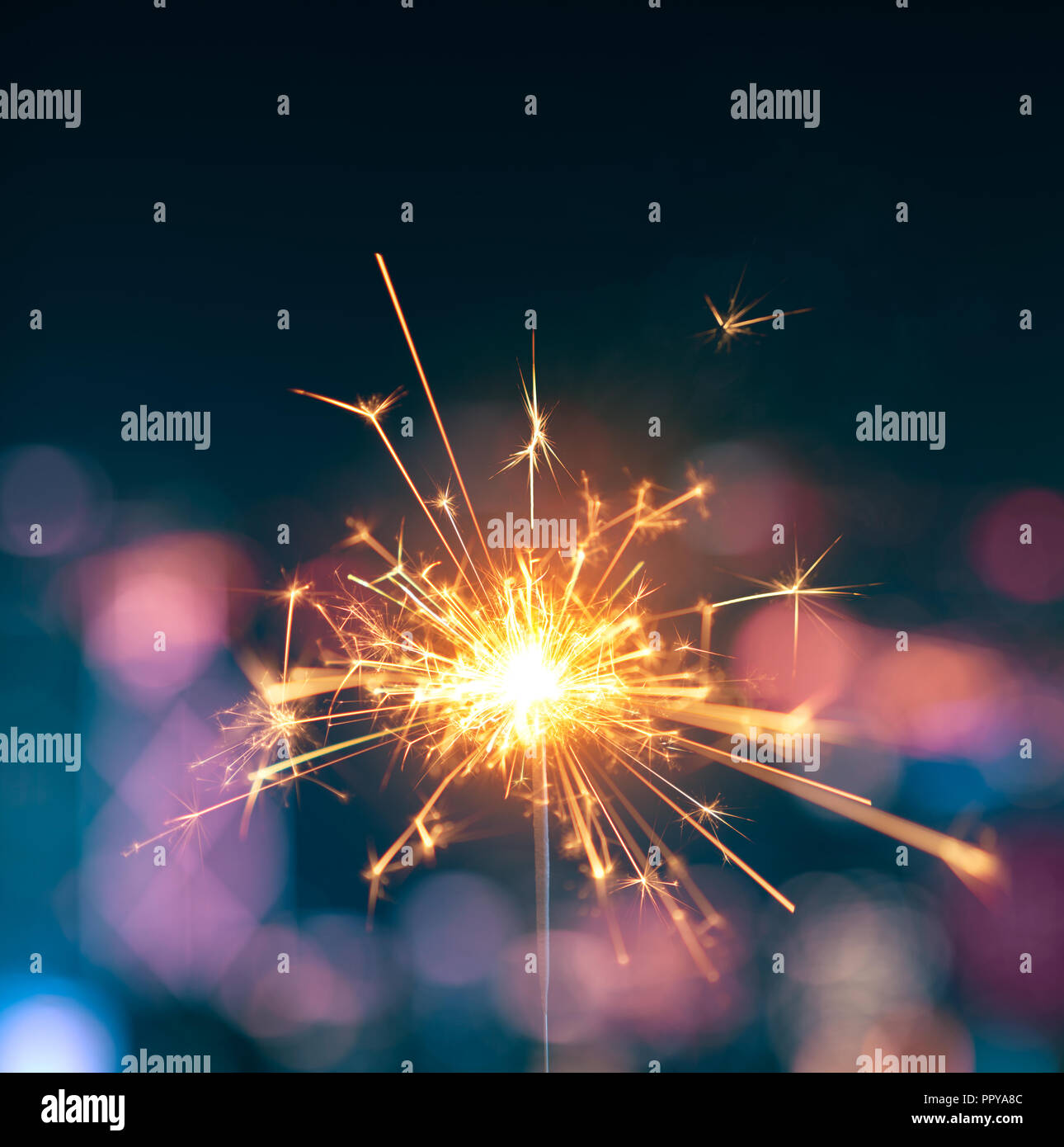 Burning sparkler with blurred background Stock Photo - Alamy