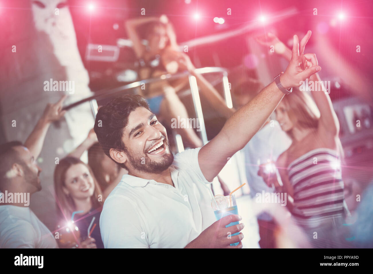 Happy cheerful positive smiling male joying and thumbs up on party in ...
