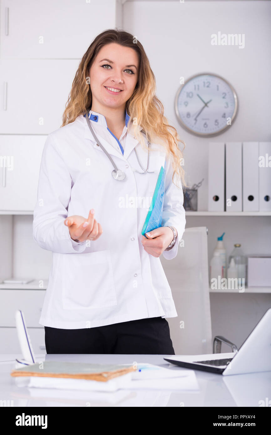 Portrait of young medical worker in medical center standing near the ...