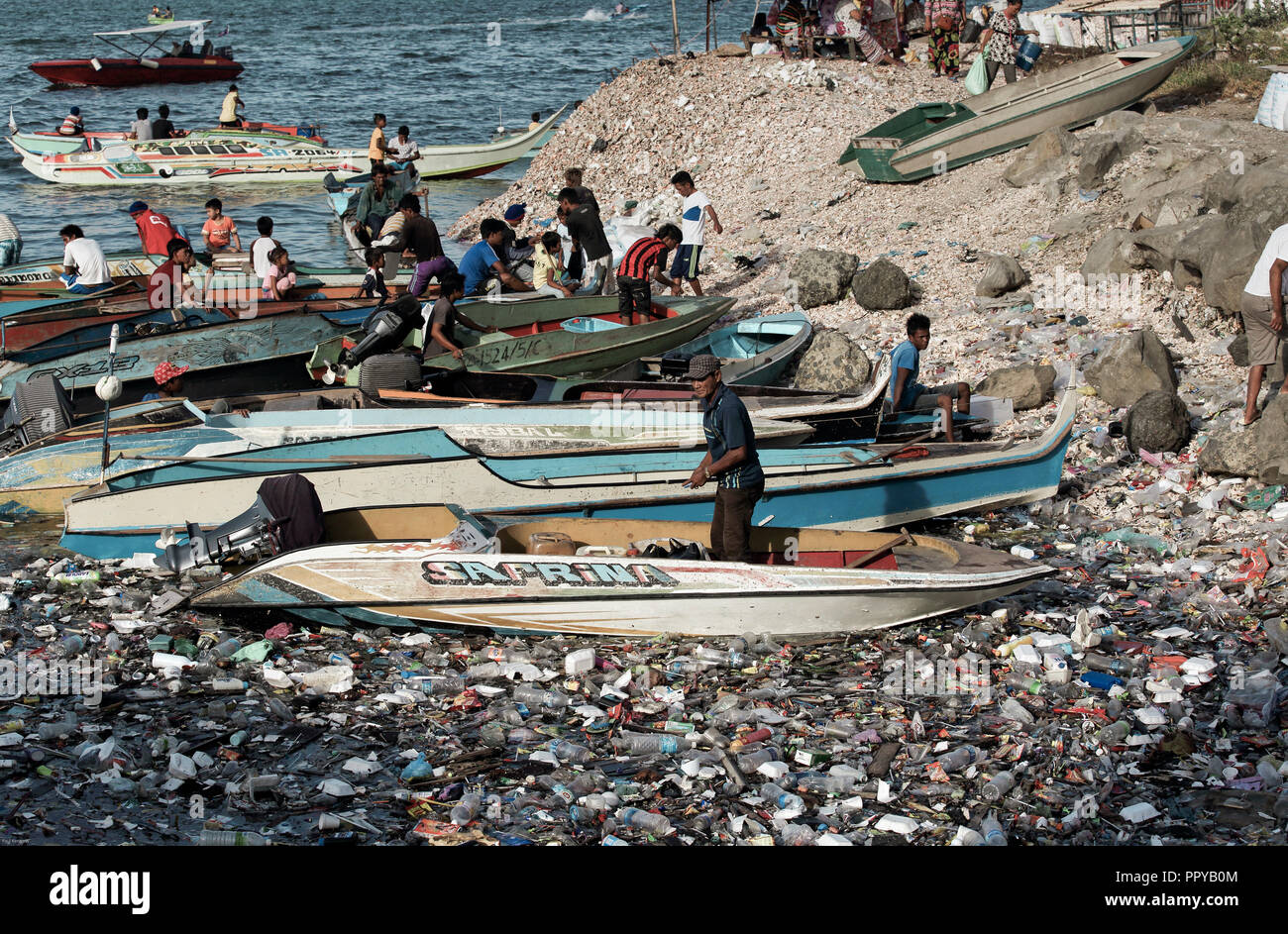 Water taxi boats operating in ocean full of plastic bags, plastic ...
