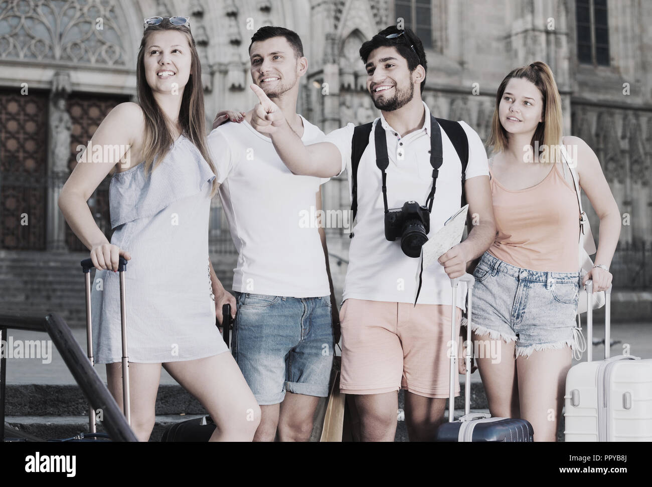 Group of people searching for direction using paper map in city Stock ...