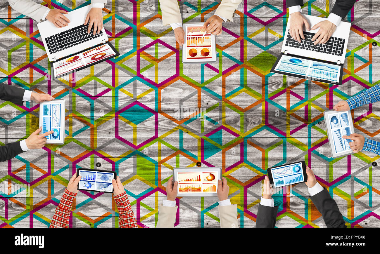 Top view of businesspeople sitting at table and using gadgets Stock ...