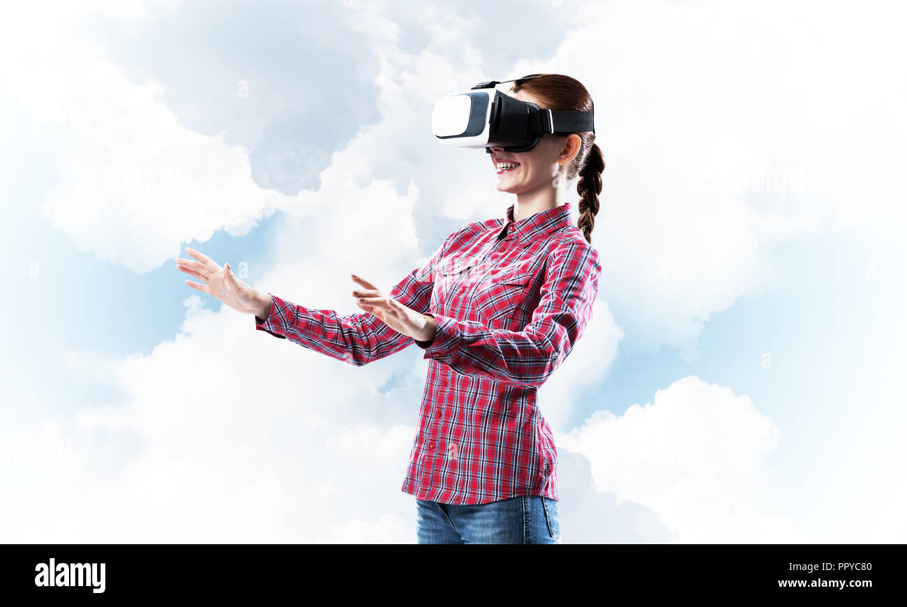 Girl in checked shirt wearing VR glasses experiencing another re Stock ...