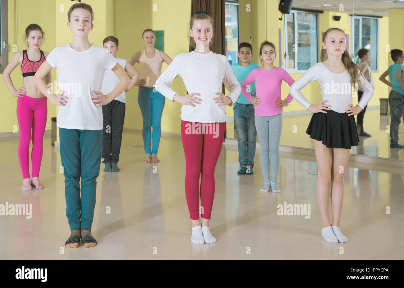 Teenagers dancers practicing dance routine with female choreographer in ...