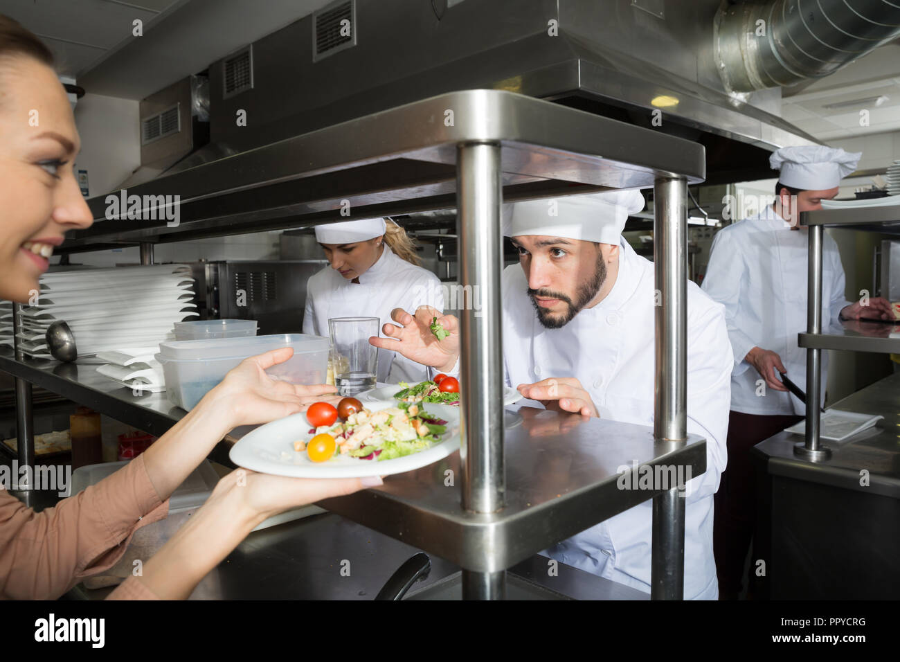 Chef of restaurant with team of cooks busy to preparing food for they ...