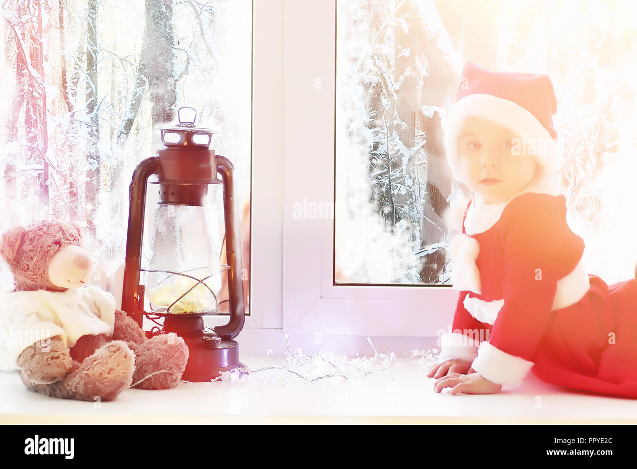 A child in the new year looks out the window. Children are waiti Stock ...