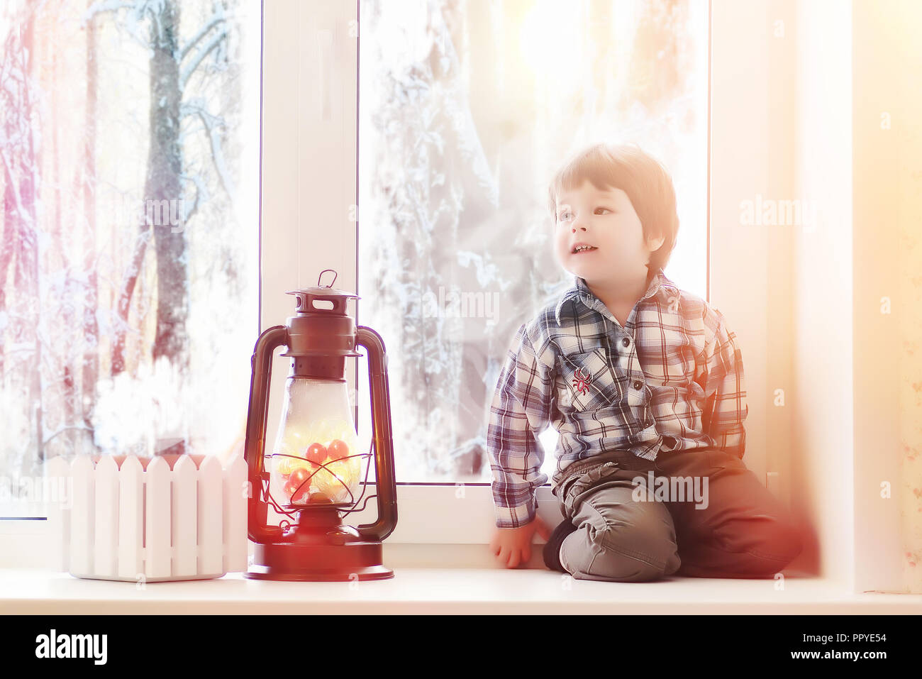 A child in the new year looks out the window. Children are waiti Stock ...