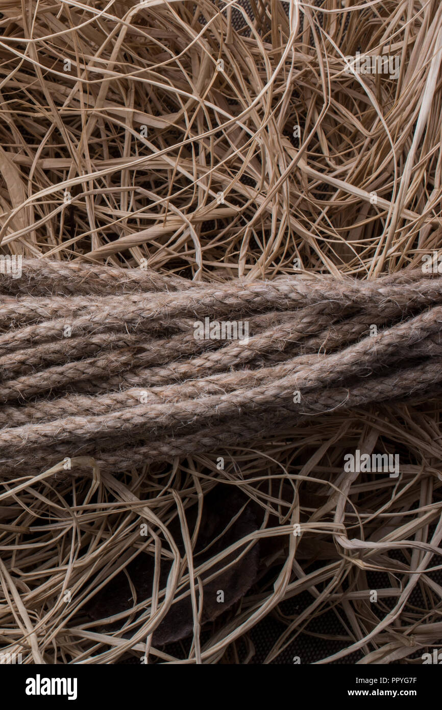 Bundle of linen rope in a straw background Stock Photo - Alamy