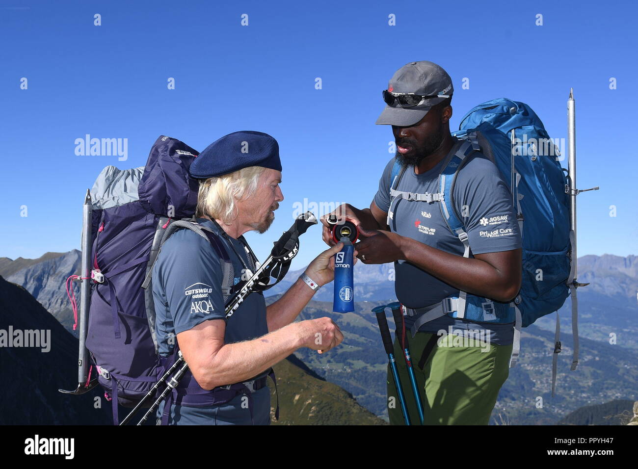 Sir Richard Branson (left) and former gang leader Karl Lokko stop for ...