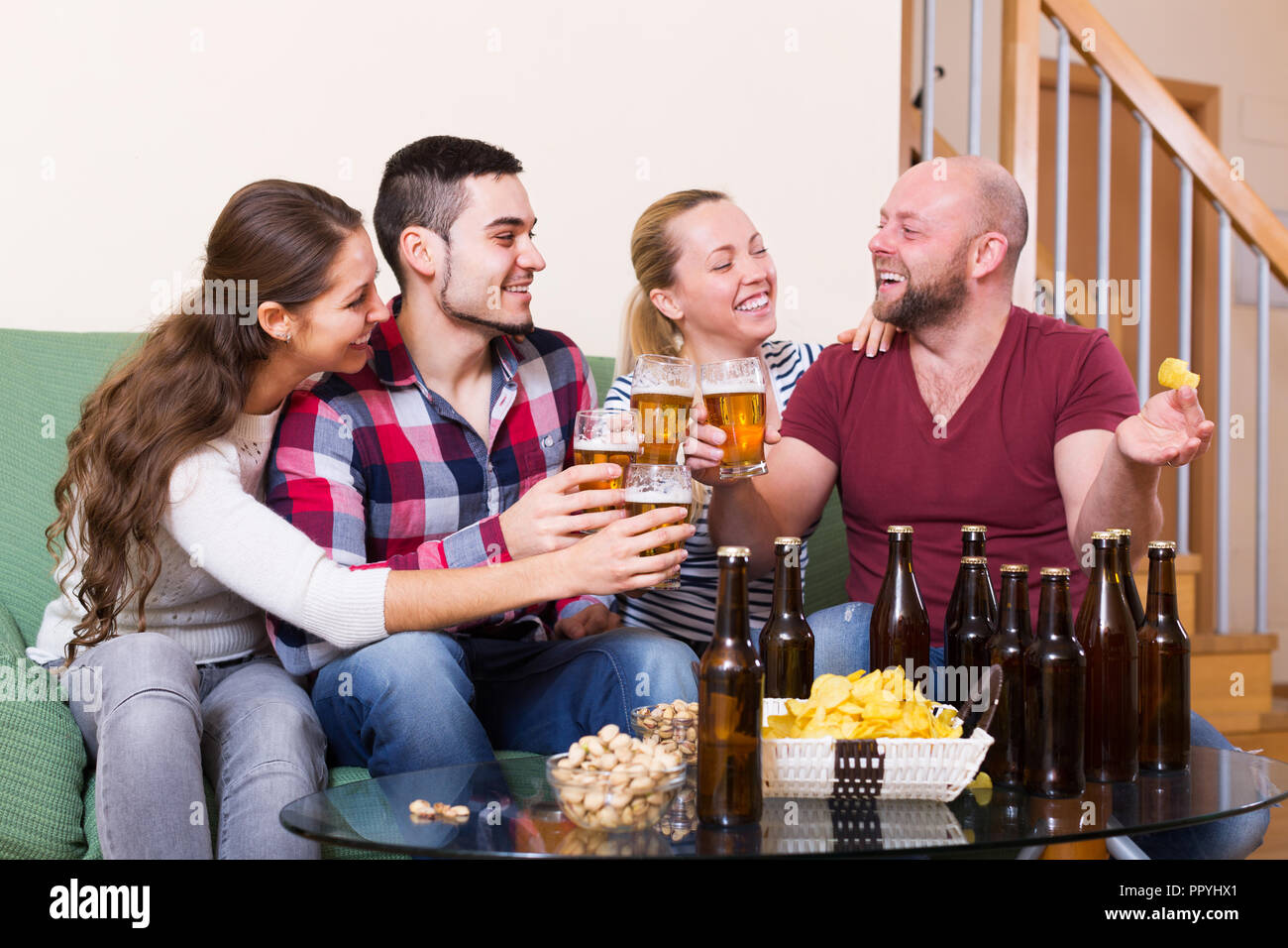 Two joyful couples having fun at house party together Stock Photo - Alamy