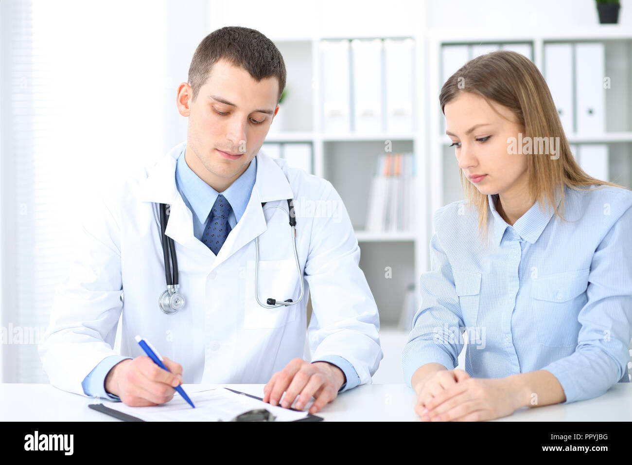 Doctor and patient sitting at the desk. Medicine and health care ...