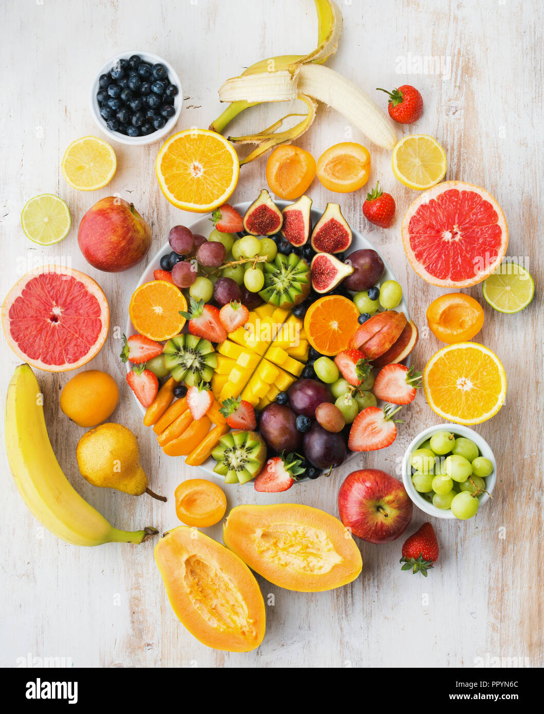 Variety of cut fruits and berries platter, strawberries blueberries ...
