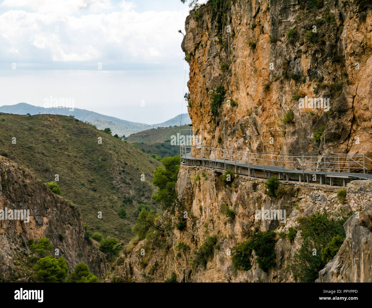 Steep gorge cliff with metal walkway, Sierras de Tejeda Natural Park ...