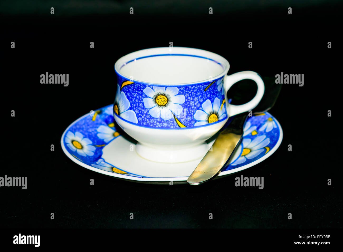 Single coffee cup on the plate with spoon in dark background Stock ...