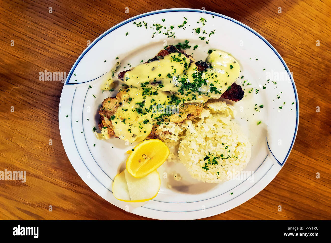 Fried zander fish fillet on rice with spices and cream sauce Stock ...