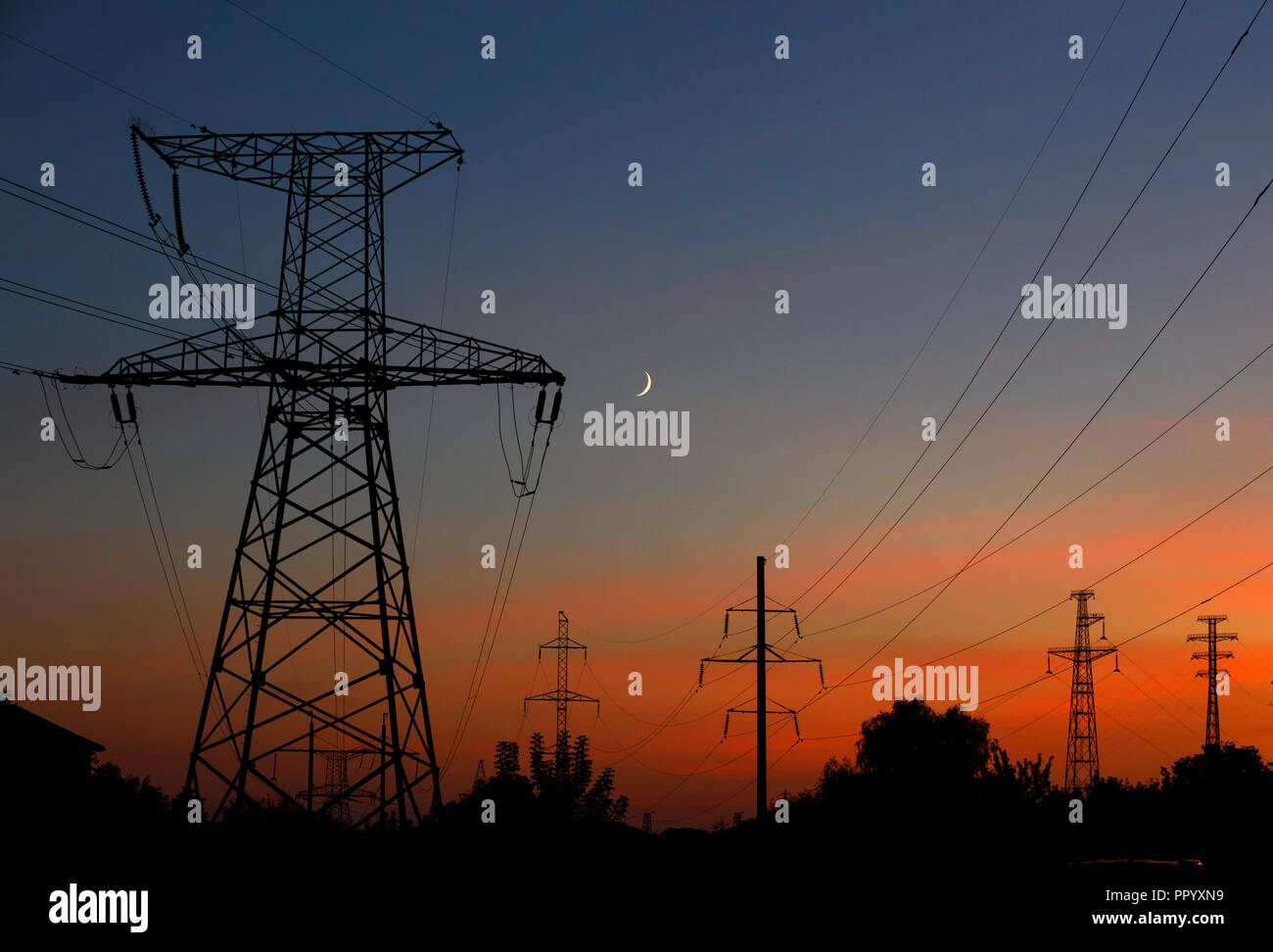 Electrical lines under a night sky with moon. power electric line and ...