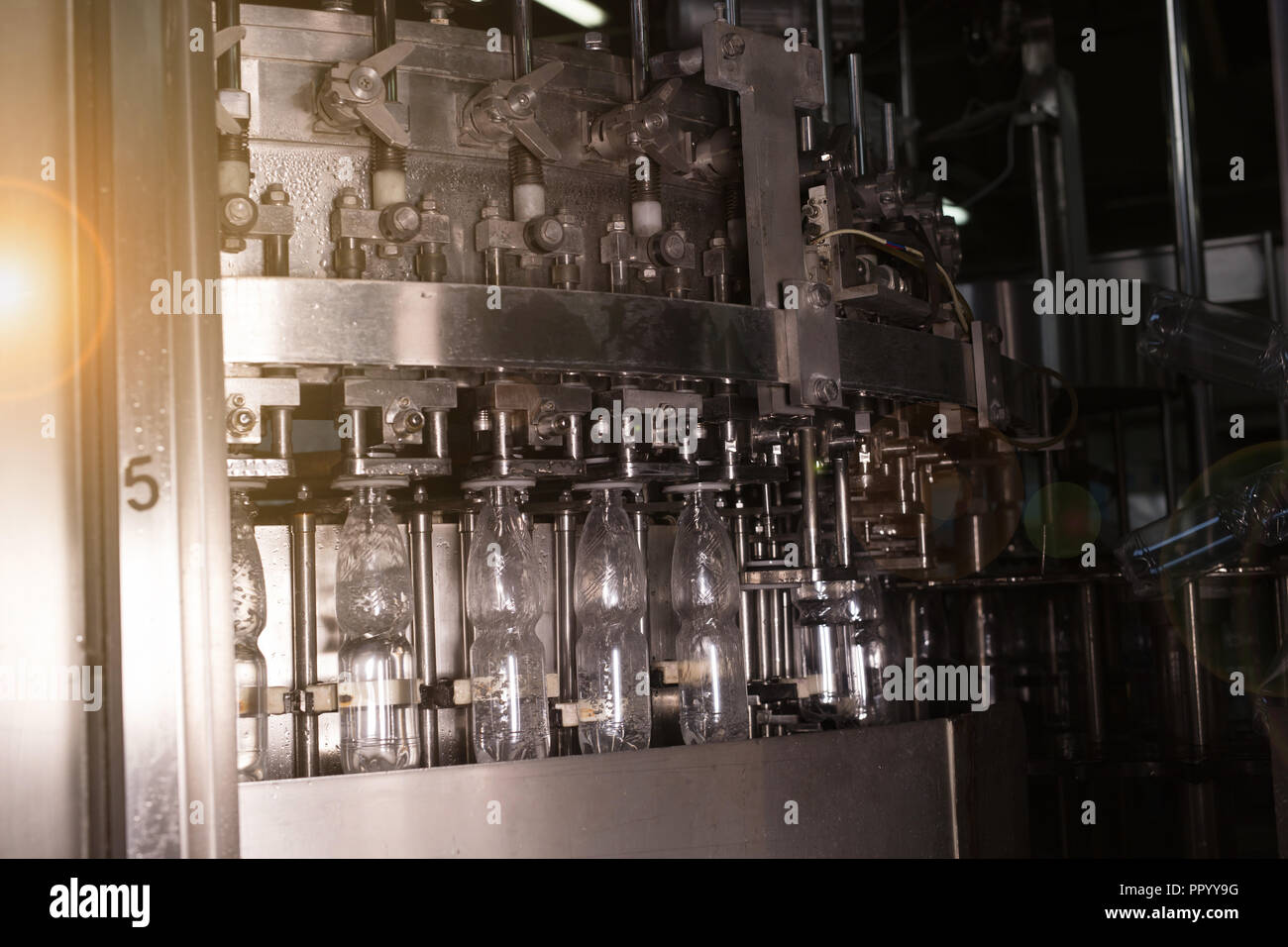 Water bottles on production line. Bottling mineral water into small ...