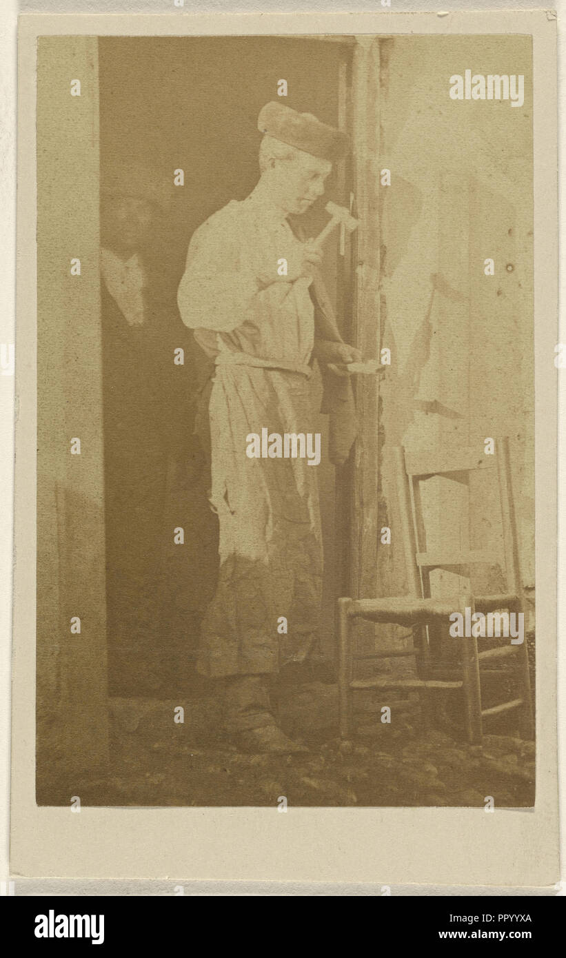 man wearing a round cap, using a hammer; 1870-1875; Albumen silver ...