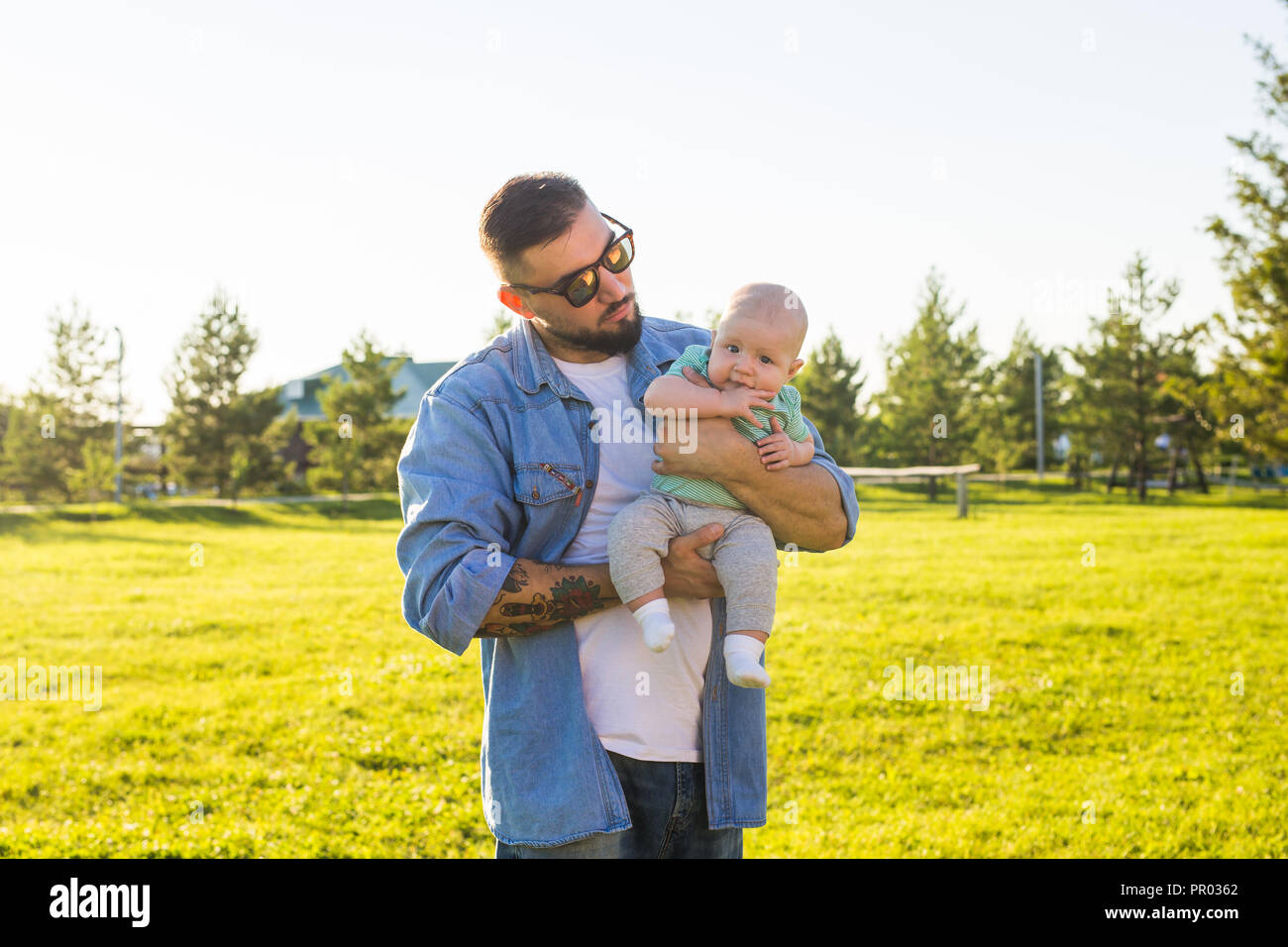 Happy father holding baby son, throwing baby in air. Concept of happy ...