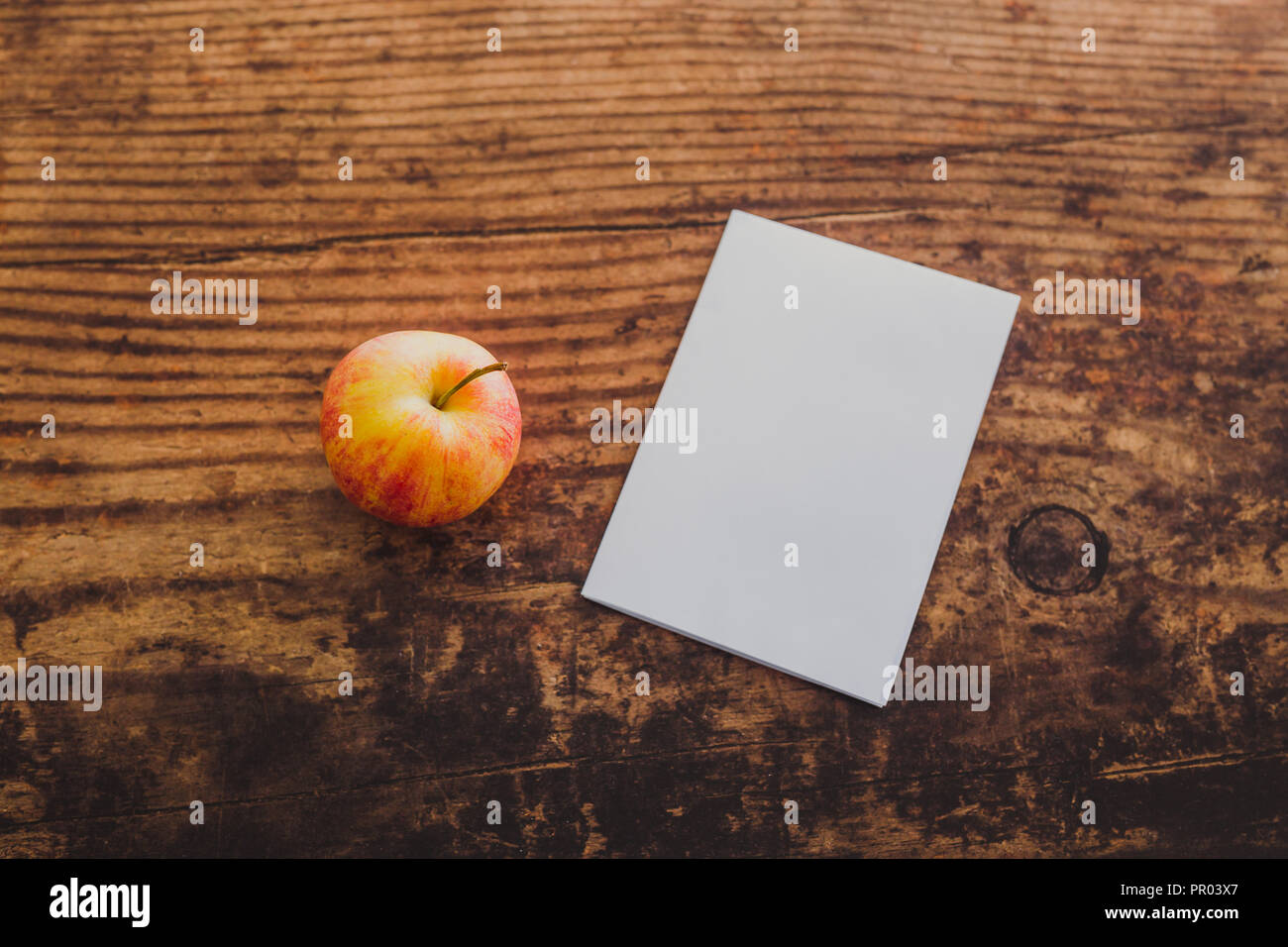 apple and copyspace on memo paper all on wooden surface background ...