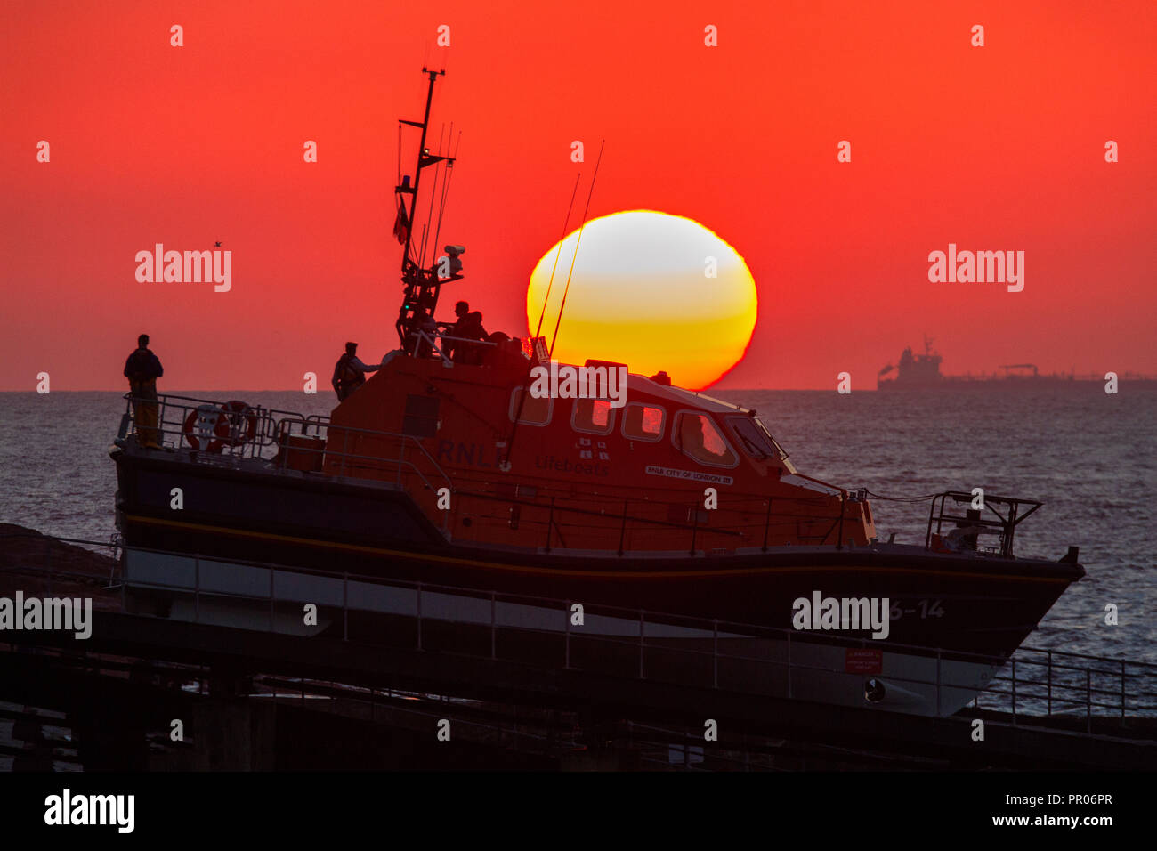 Sennen Lifeboat launches at sunset on a training evening Stock Photo ...