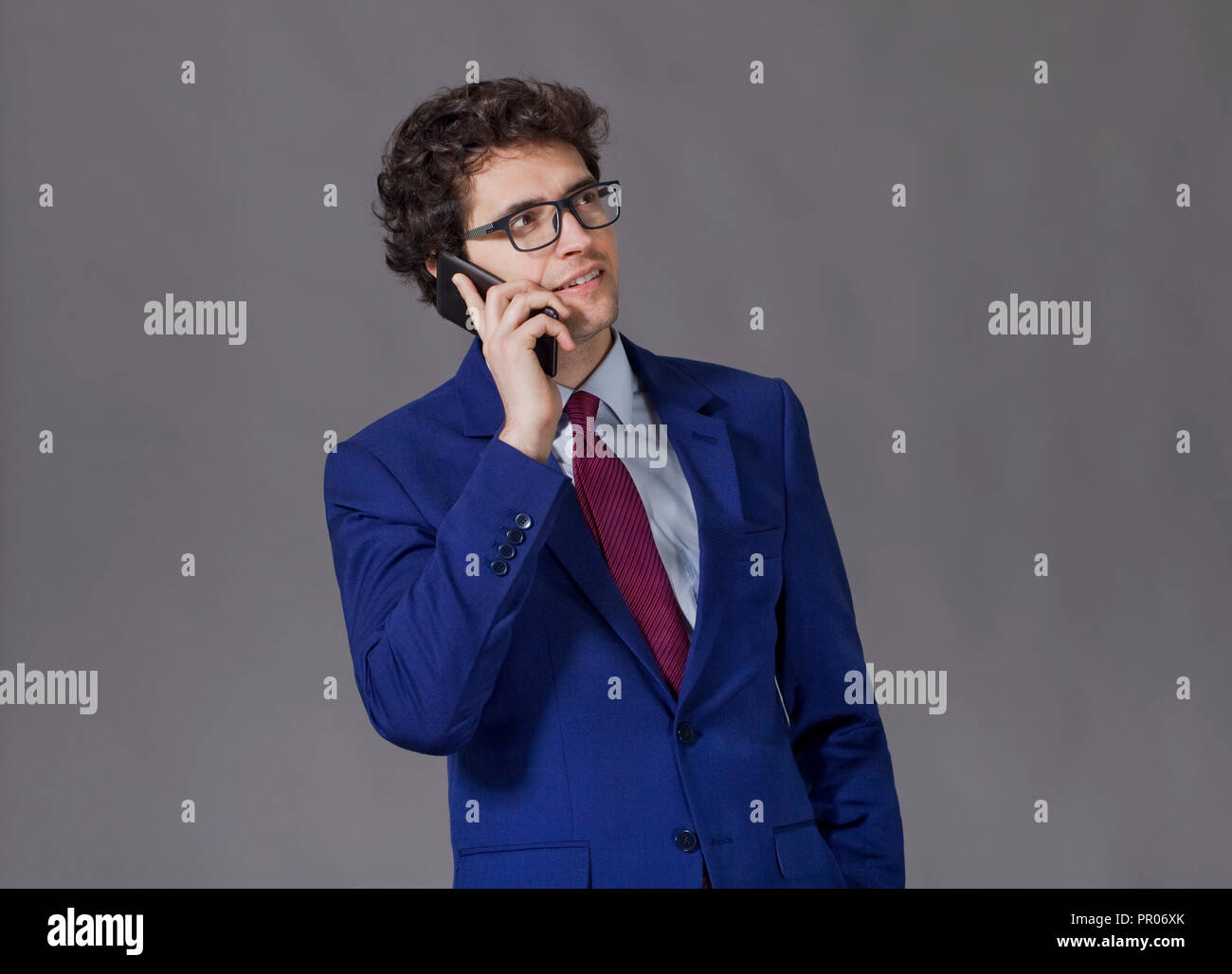 Intelligent young man answering the phone call Stock Photo - Alamy
