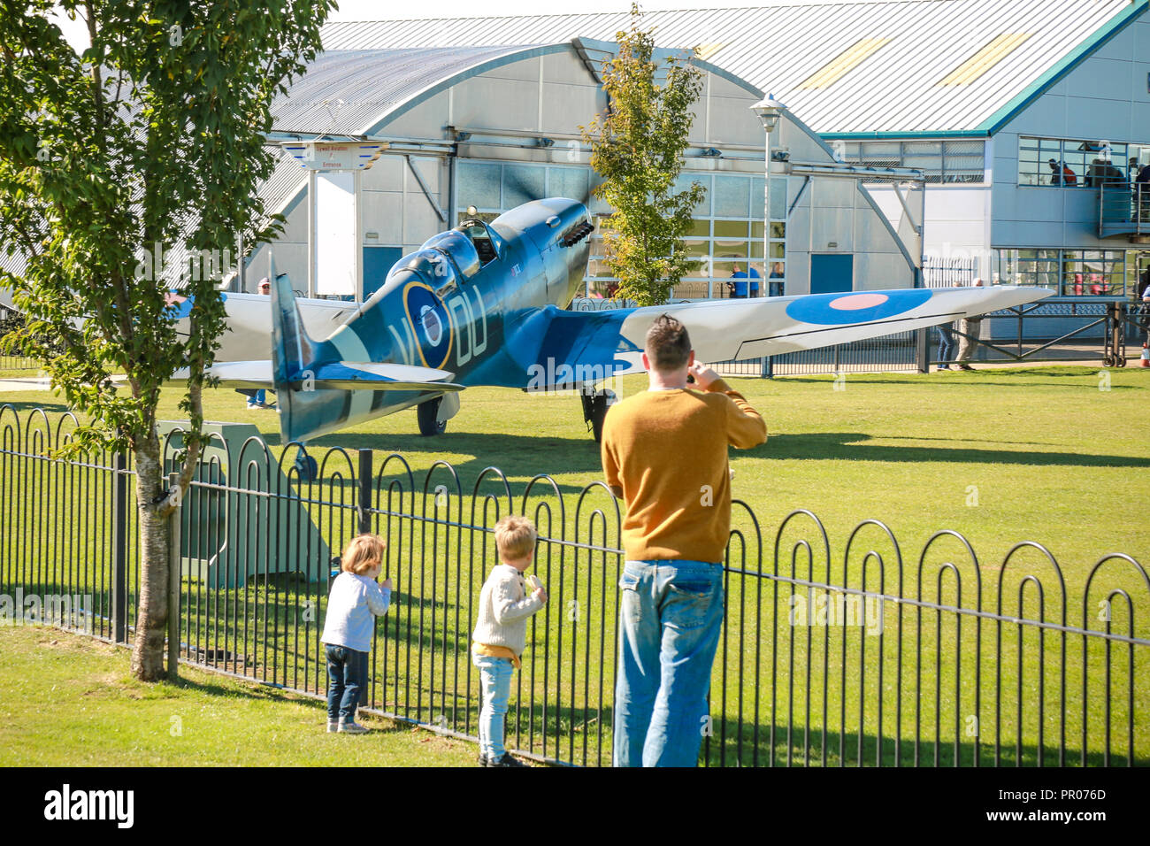 A man and his children watch as a Spitfire passes close by at Sywell ...