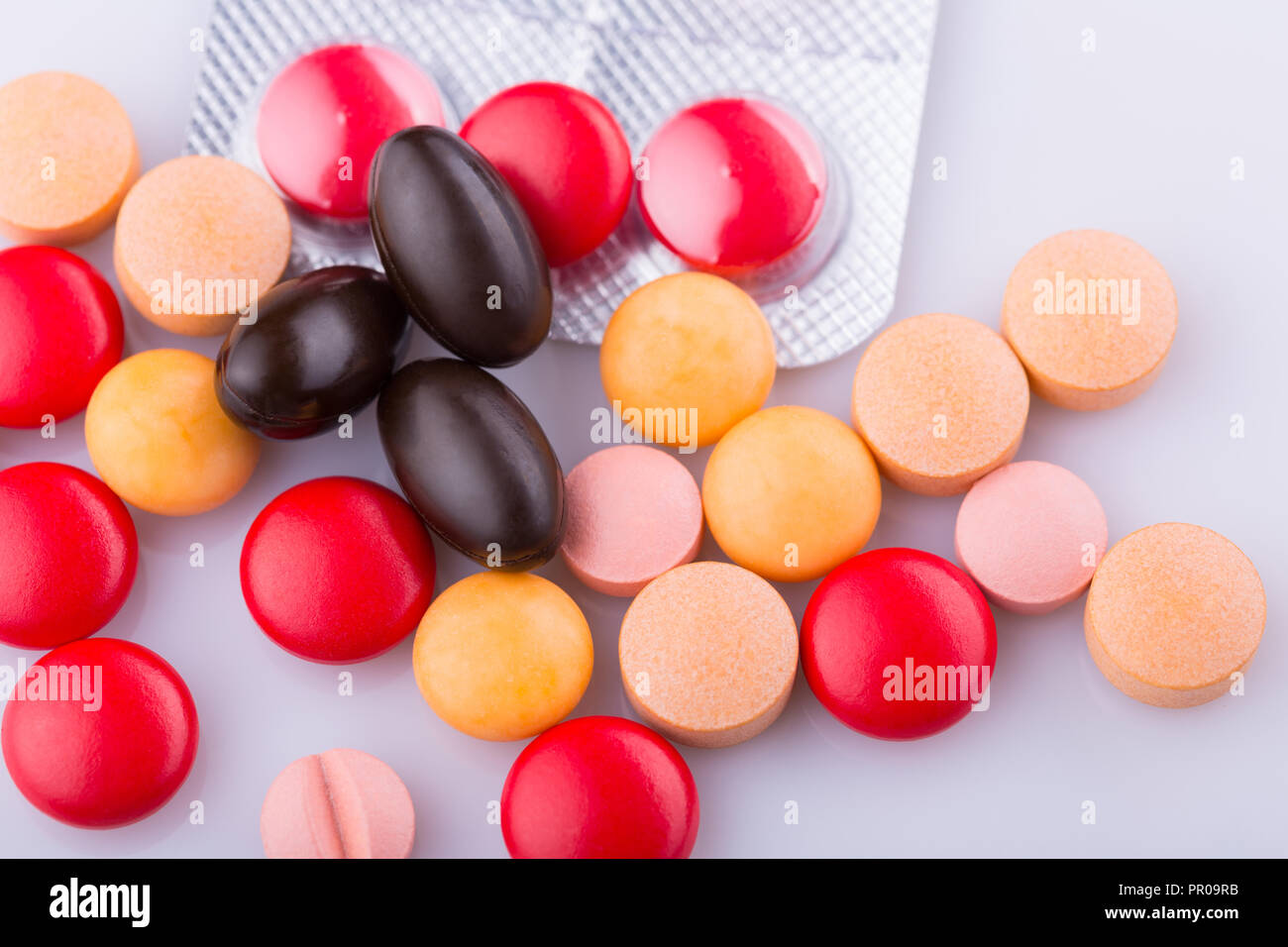 Tablets pills capsule heap mix therapy drugs, over a white background ...