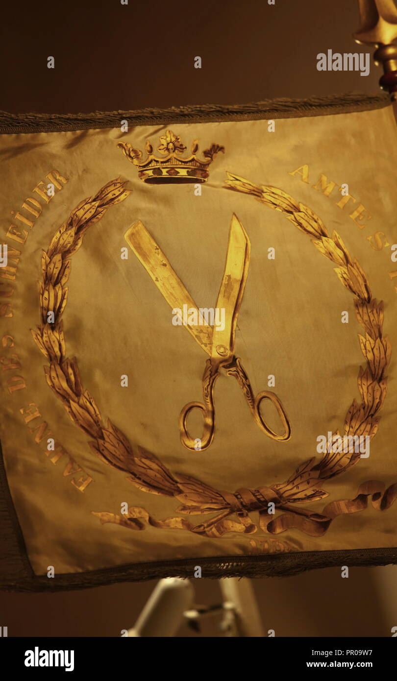 Gold scissors on the emblem of the royal tailor Stock Photo - Alamy