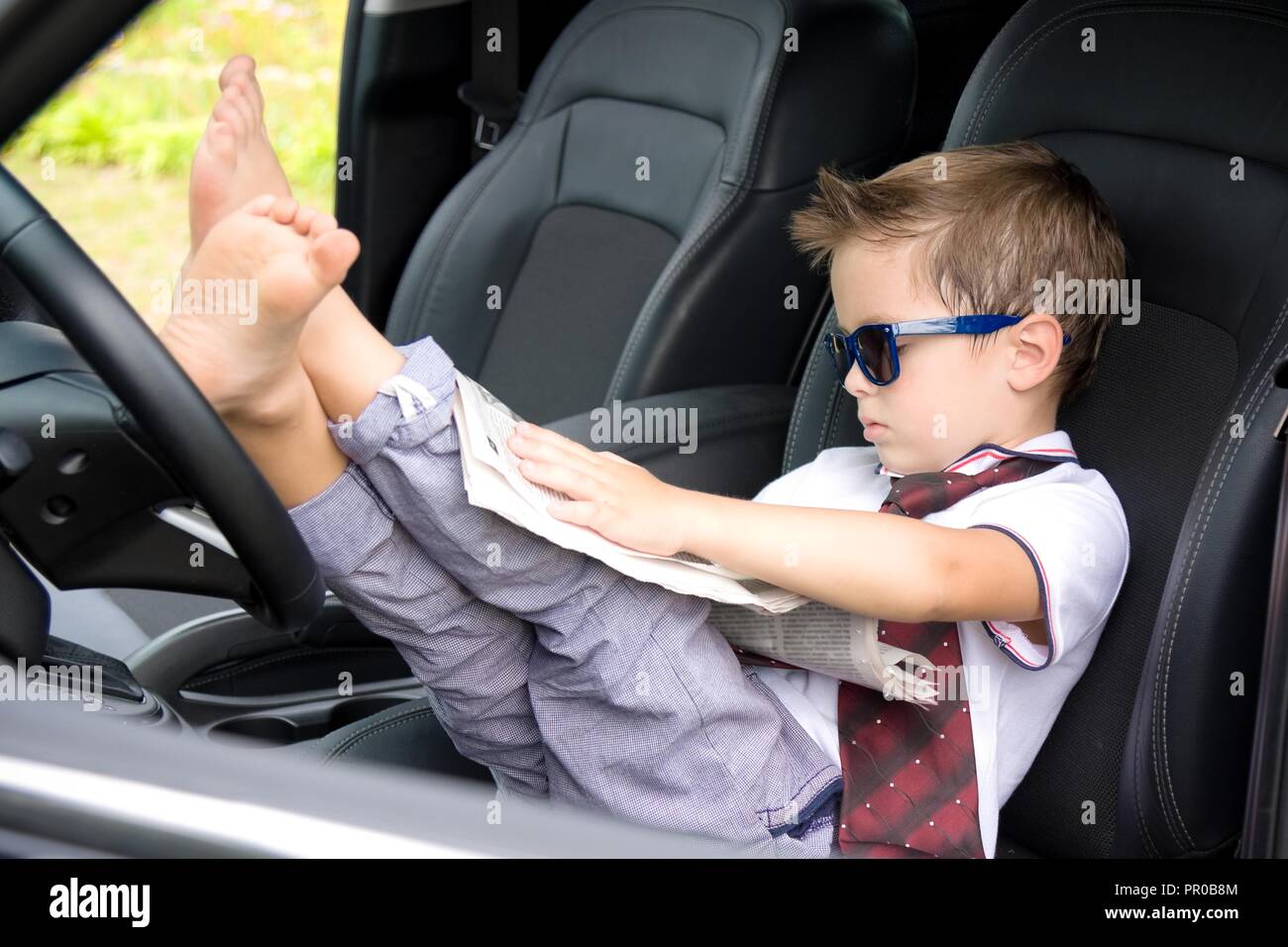 cute drive reads newspaper in car Stock Photo - Alamy