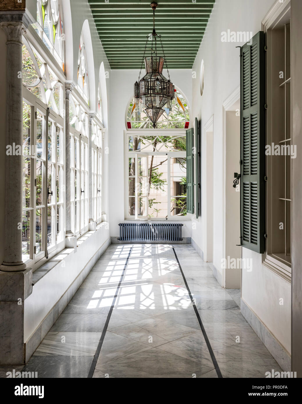 Glazed window arches in hallway above courtyard Stock Photo - Alamy