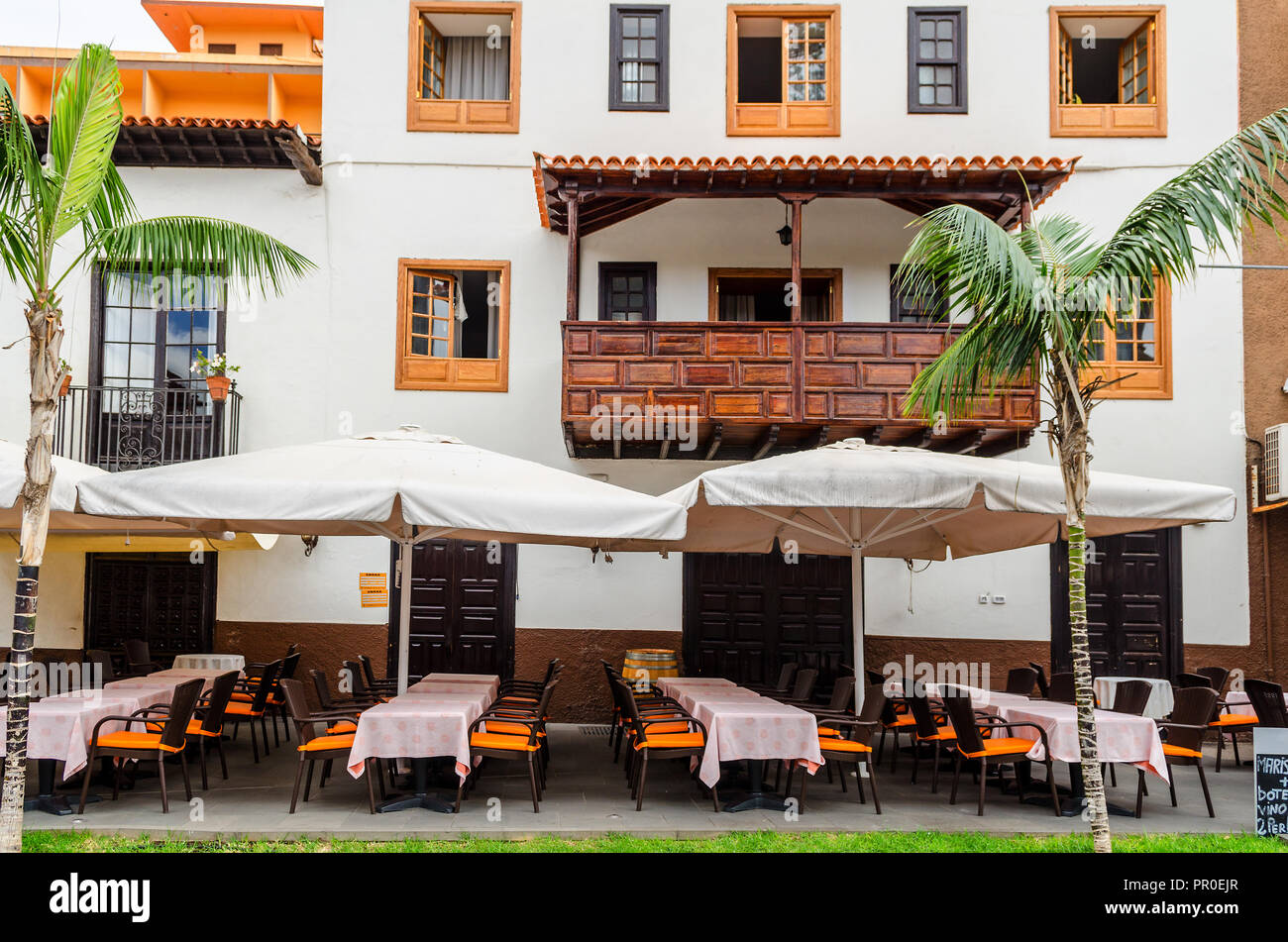 empty restaurant terrace with a traditional house in the background ...
