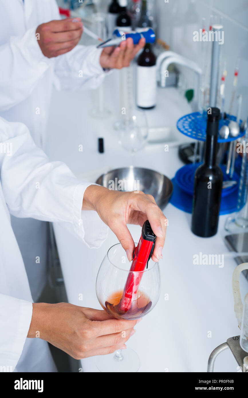 Close up on hands testing quality in chemical lab Stock Photo - Alamy