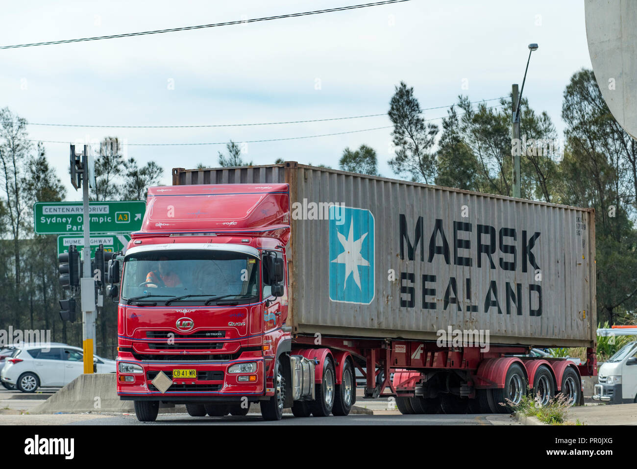 A large semi trailer truck carrying a Maersk Sealand shipping container ...