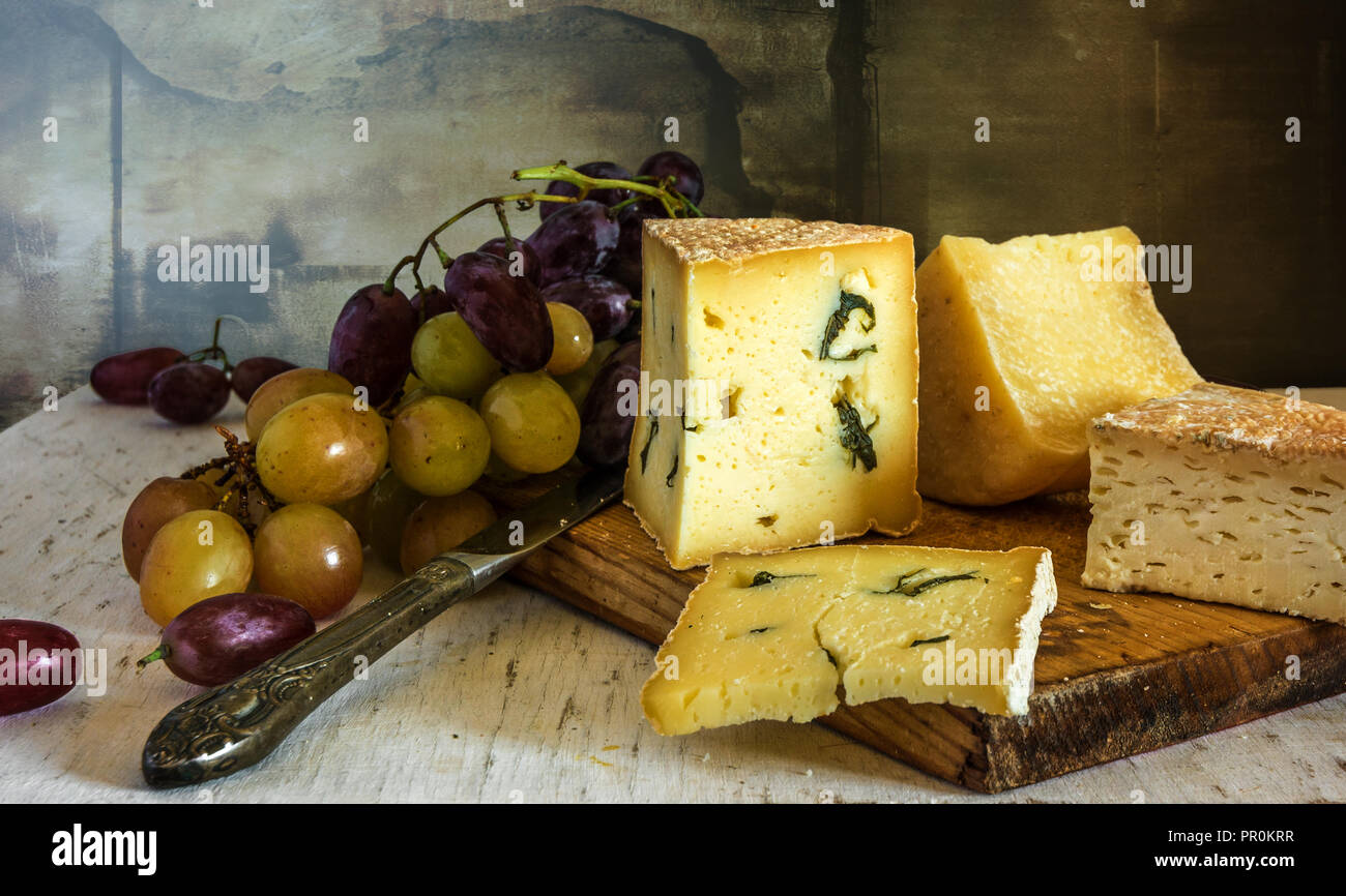 still life with pieces of cheese and grapes. food. delicious. vintage ...