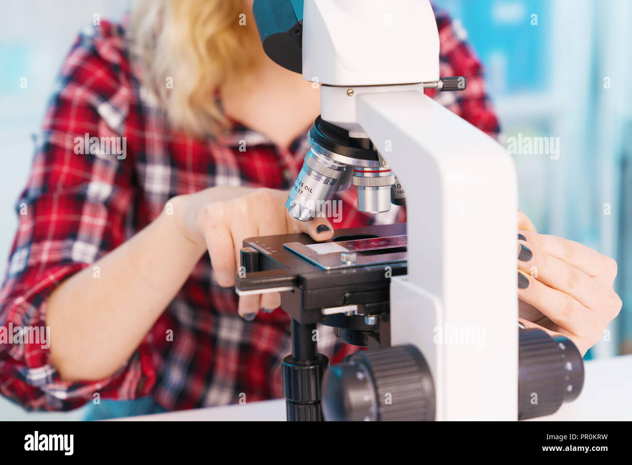 Women looking through microscope hi-res stock photography and images ...