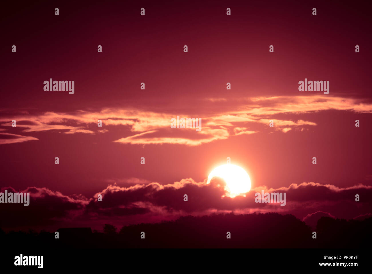 Bright big sun on the sky with clouds Stock Photo - Alamy