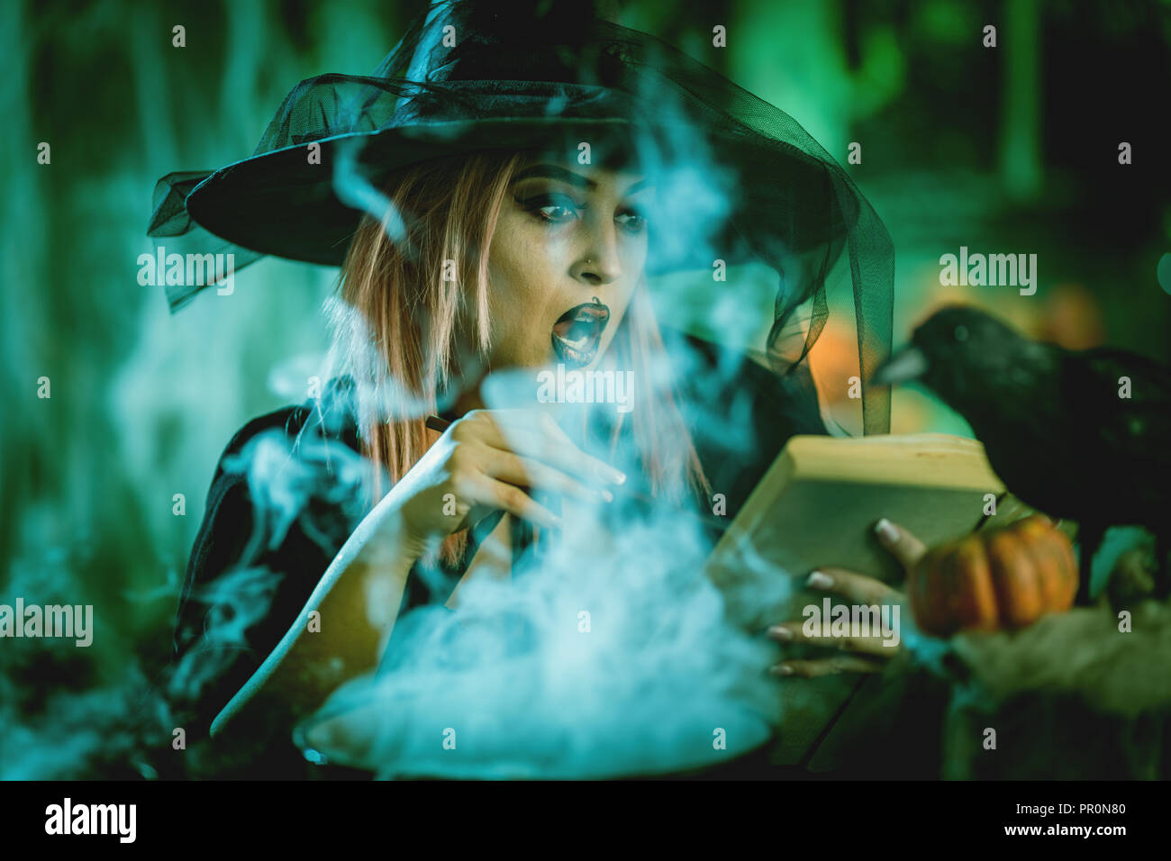 Witch with awfully face in creepy surroundings and smoky green ...