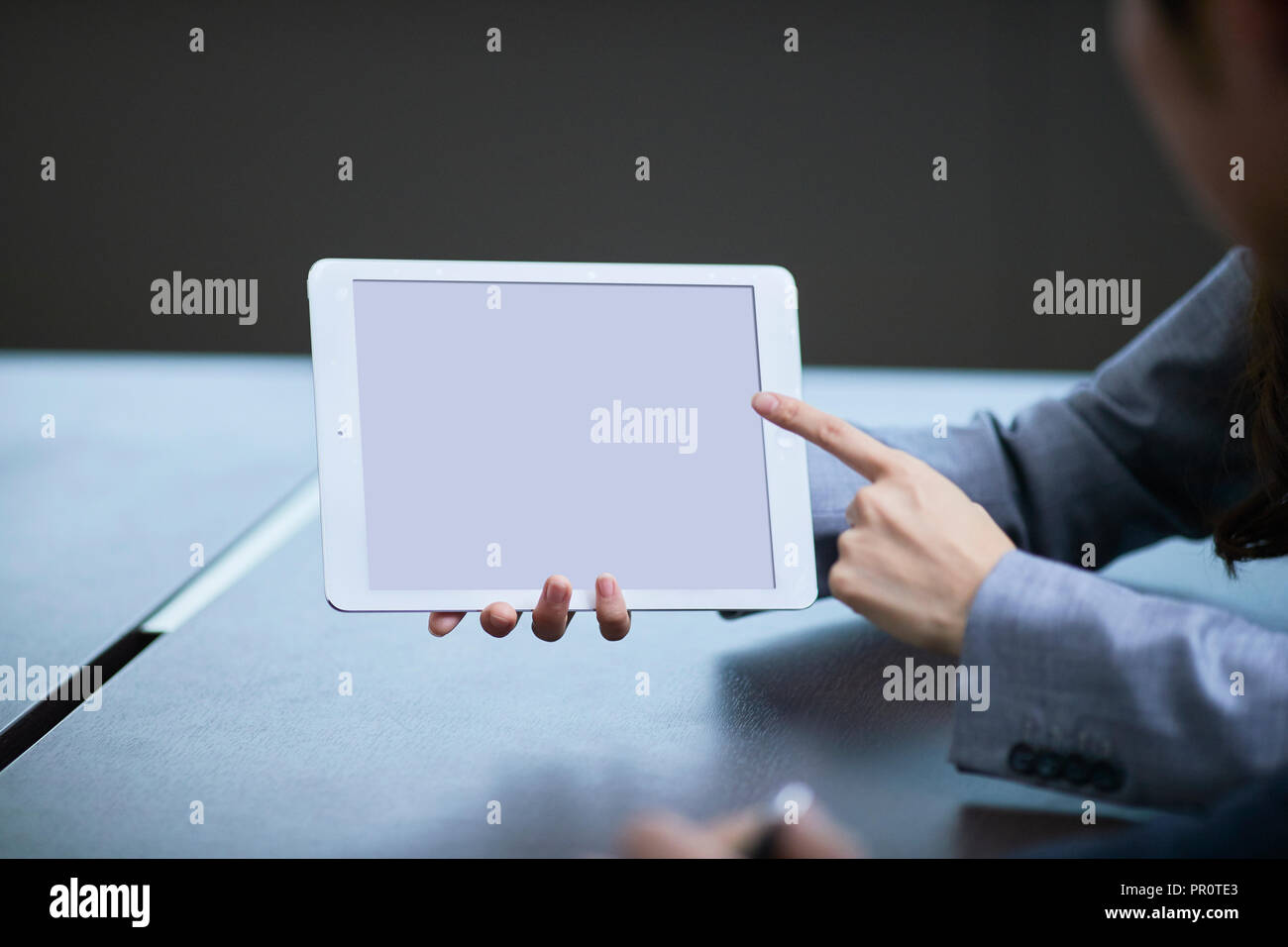 Hand holding tablet in the office Stock Photo - Alamy
