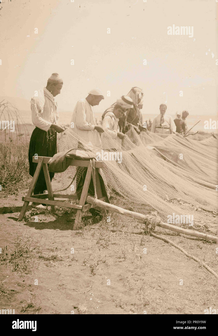Northern views Fisherman mending their nets 1900 Israel Stock Photo - Alamy