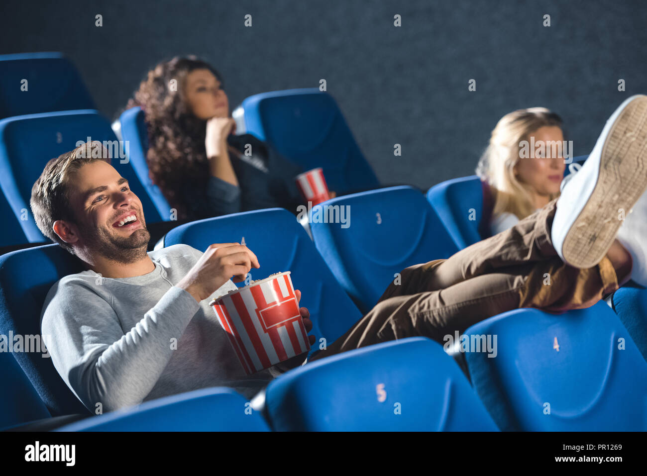 Laughing caucasian man eating popcorn hi-res stock photography and ...