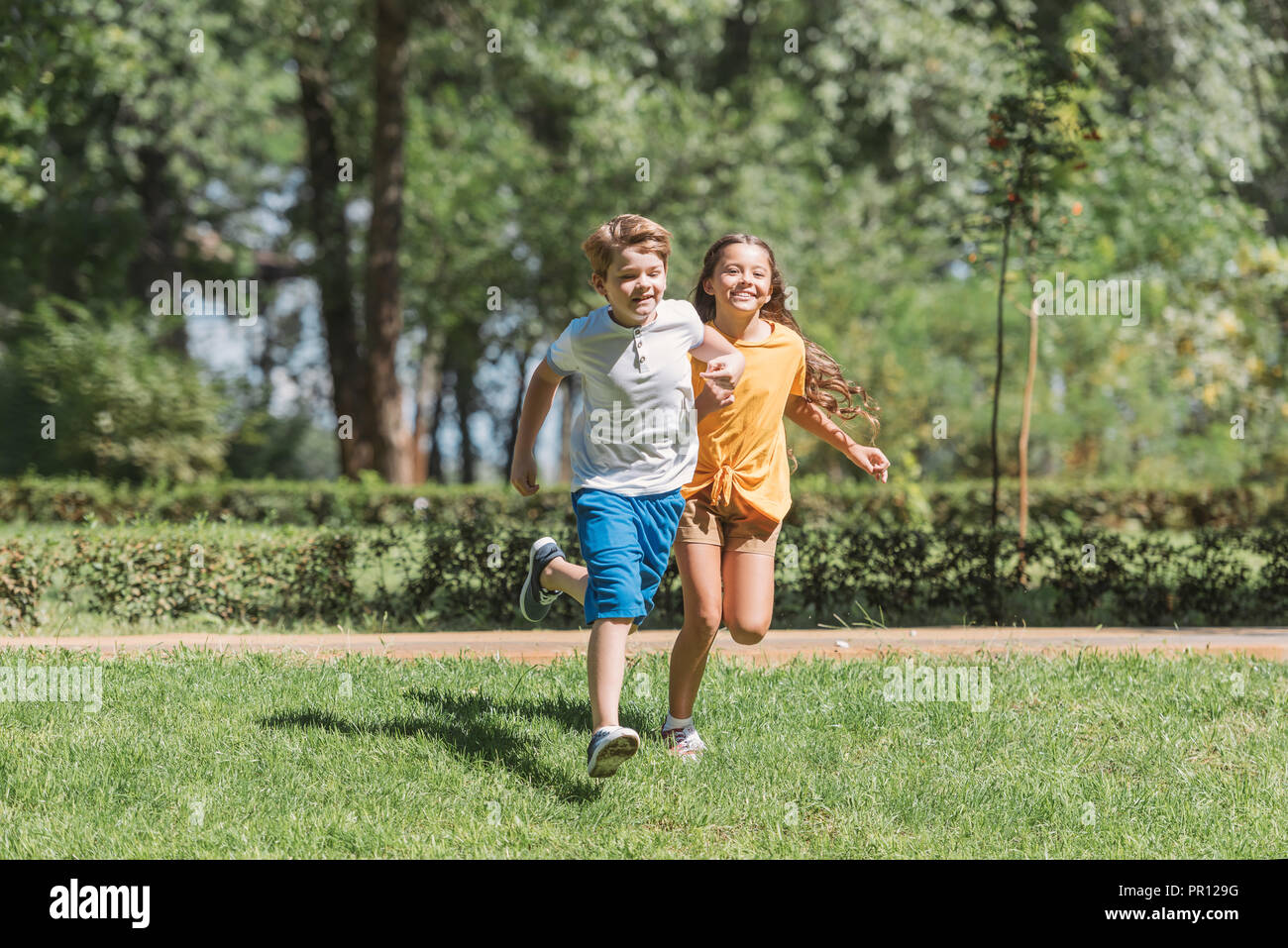 beautiful happy children running on grass in park Stock Photo - Alamy