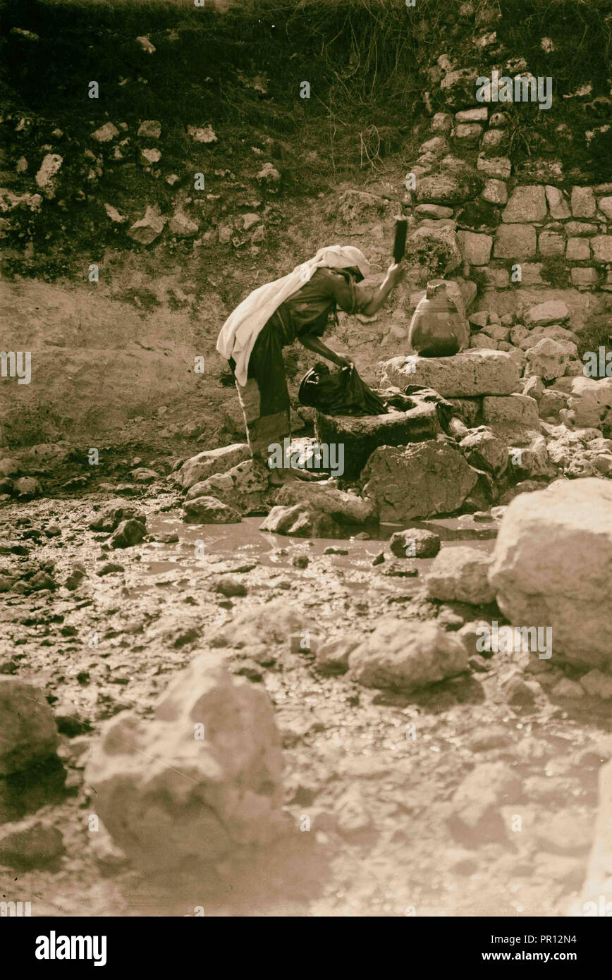 Women washing clothes at a fountain. 1900, Middle East, Israel and/or ...
