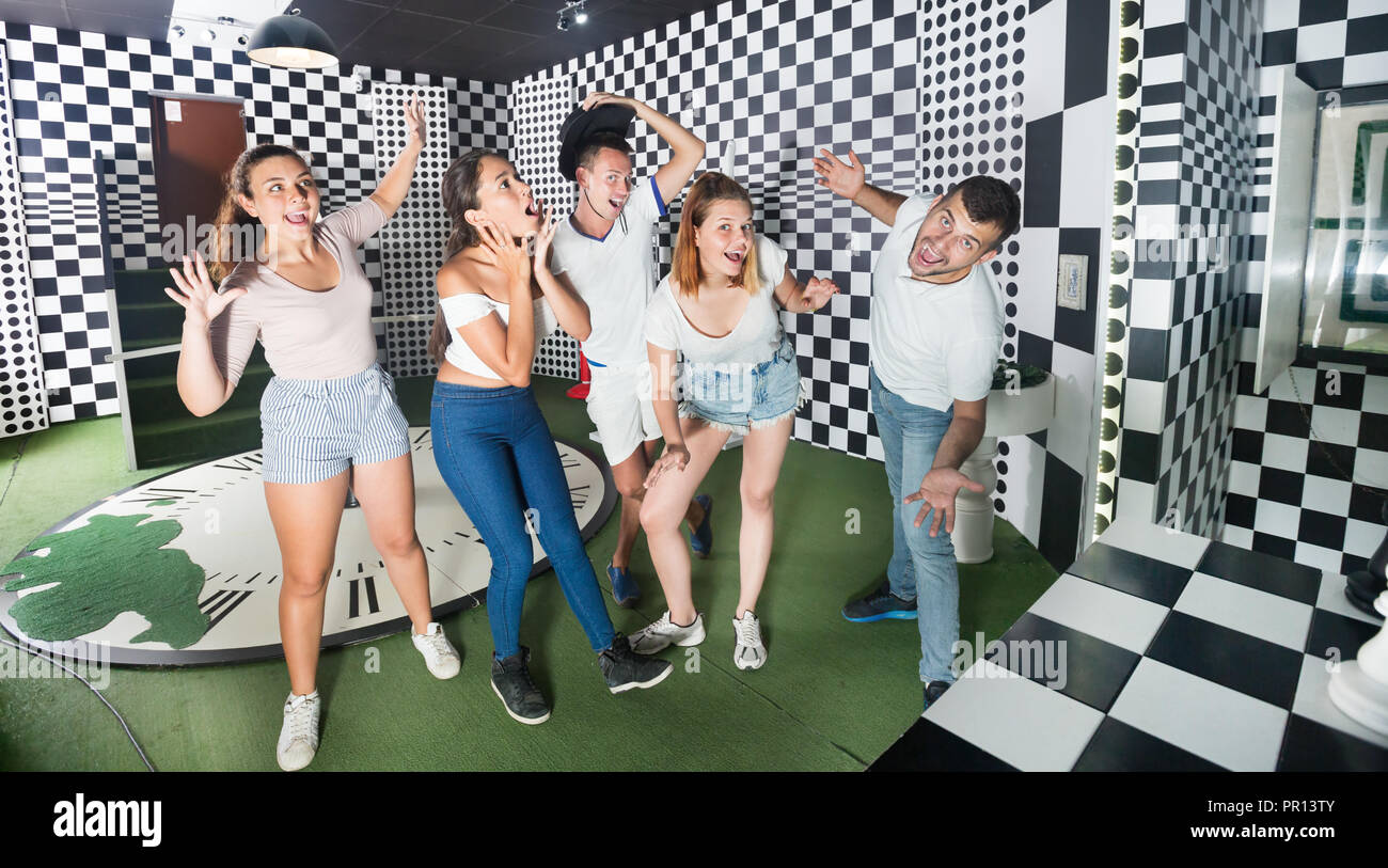 Group of young people having fun in escape room stylized under a ...