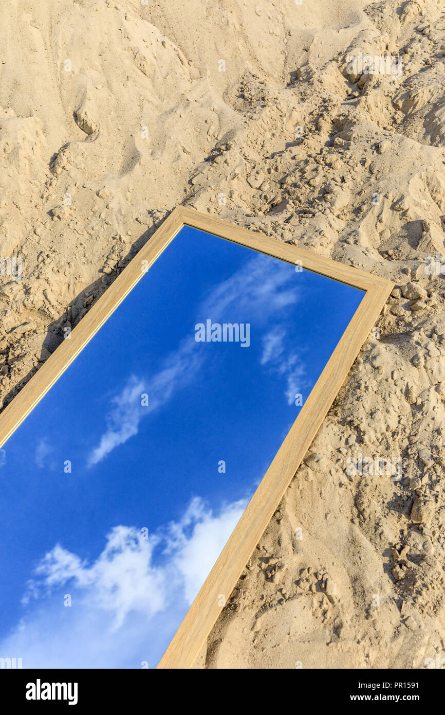 mirror with reflection of blue sky lying on beach, natural light Stock ...